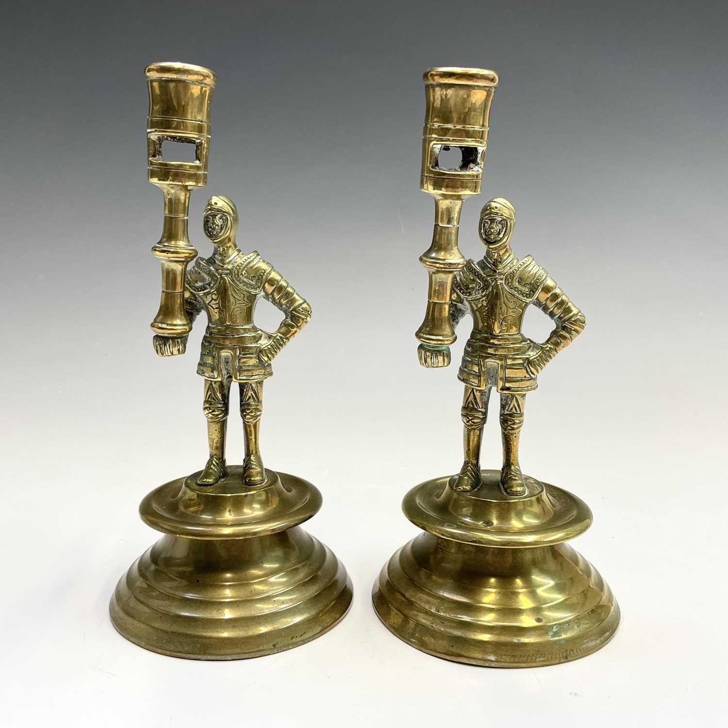 Lot 156 - A pair of brass figural candlesticks, 19th