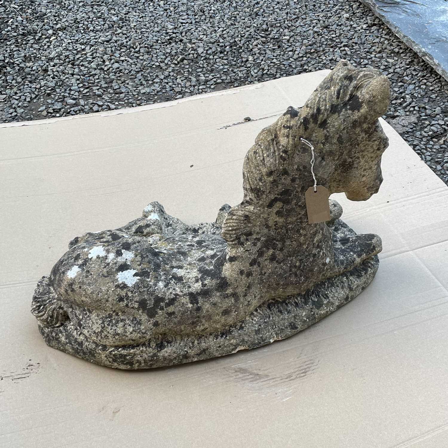Lot 615 - A cast concrete figure of a recumbent foal,