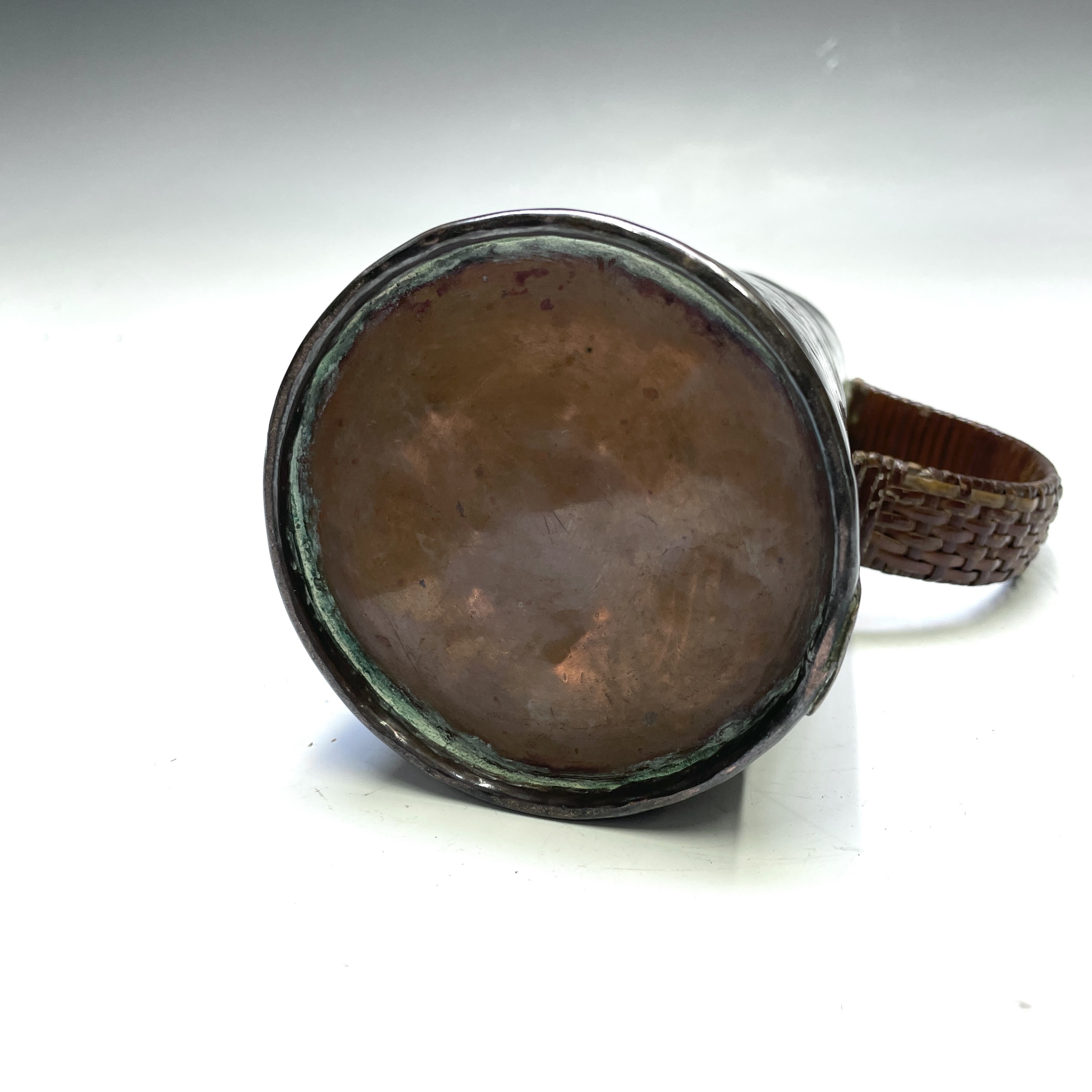 Lot 21 - A Newlyn copper jug of conical form, repousse