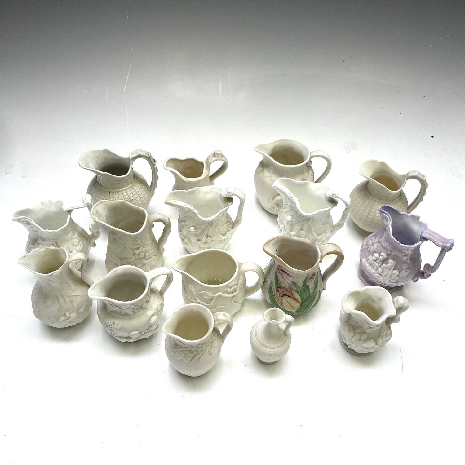 Lot 829 - Twelve Victorian miniature Parian jugs