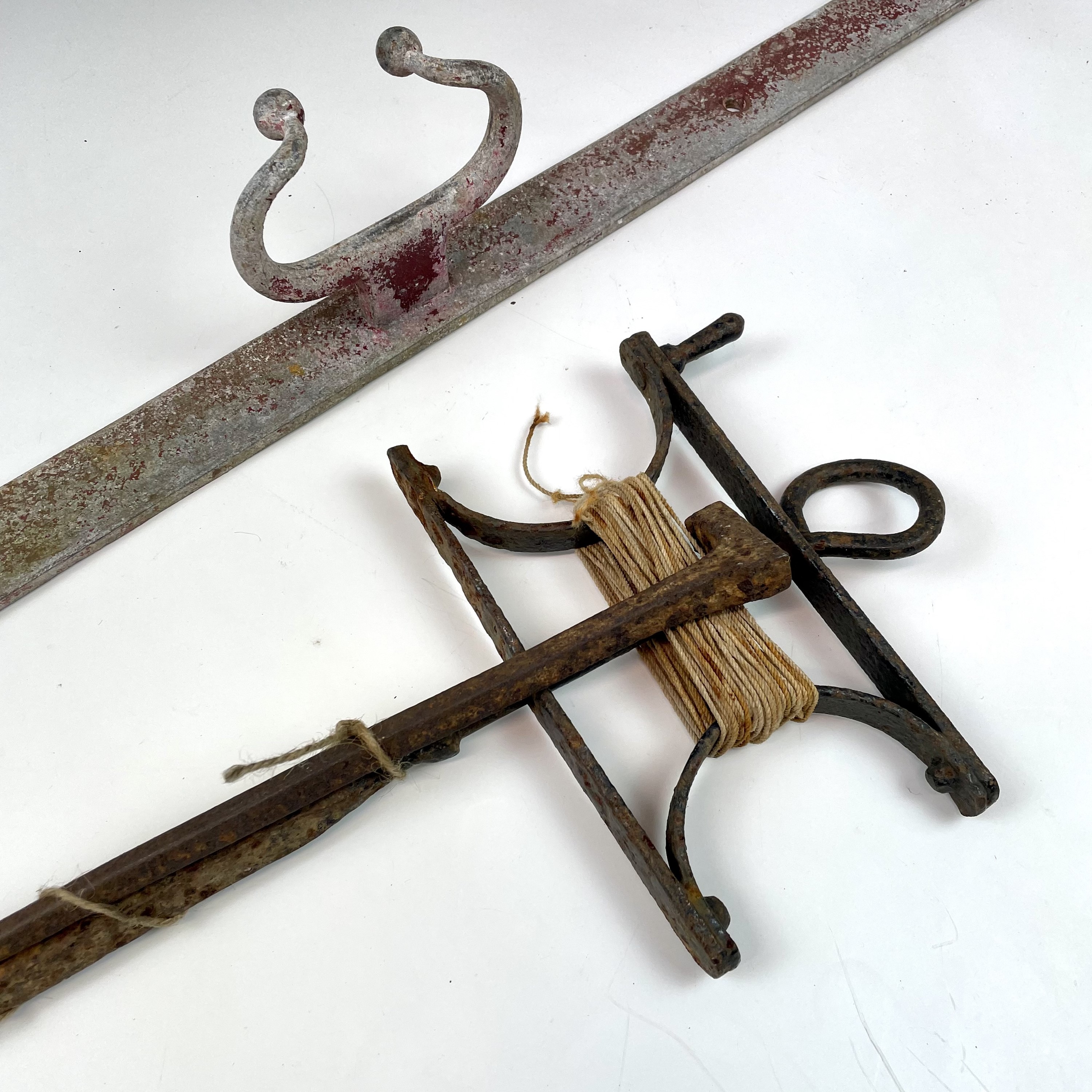 Lot 104 - A wrought iron garden string line and winder,