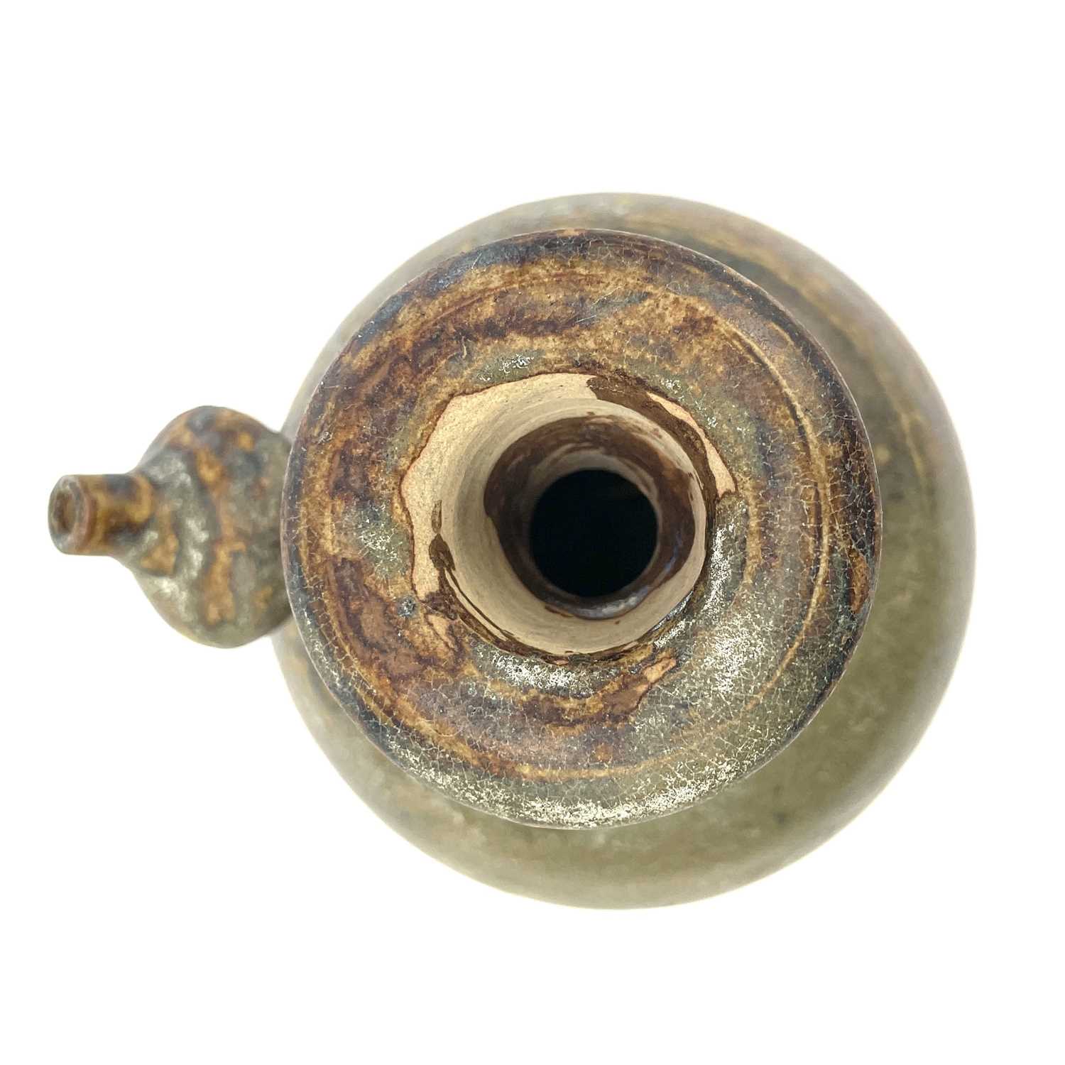 Lot 860 - A mottled tea dust glaze pottery kendi,