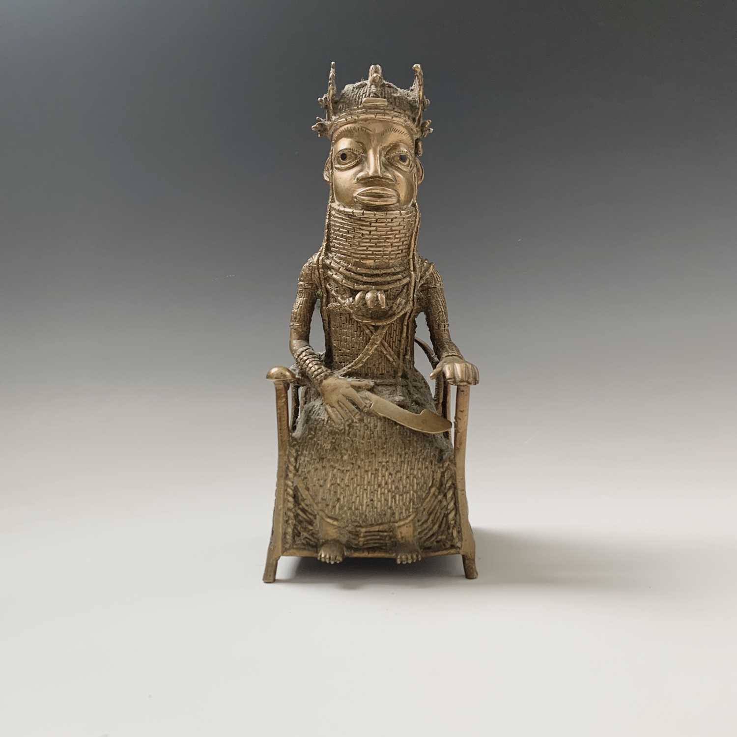 Lot 229 - A Benin bronze model of a seated chief,