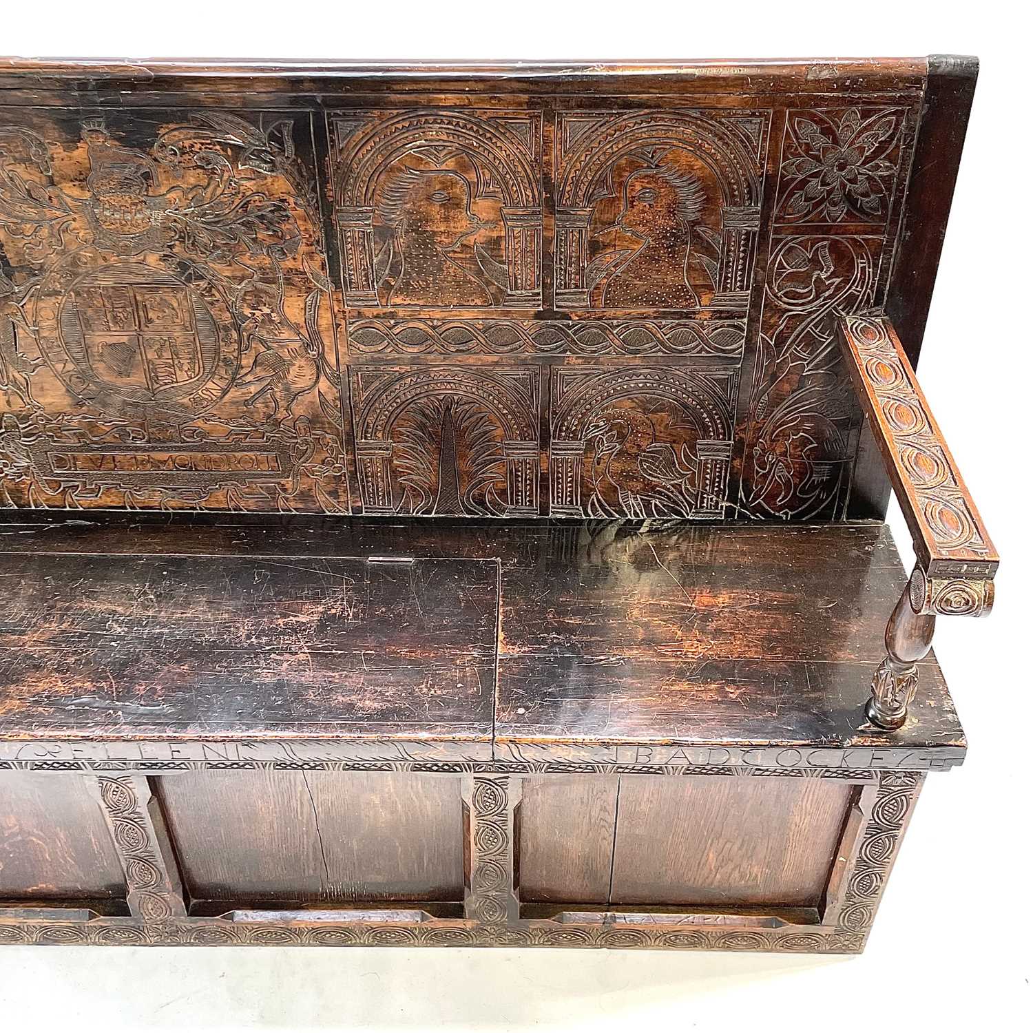 Lot 8 - A carved oak hall settle.