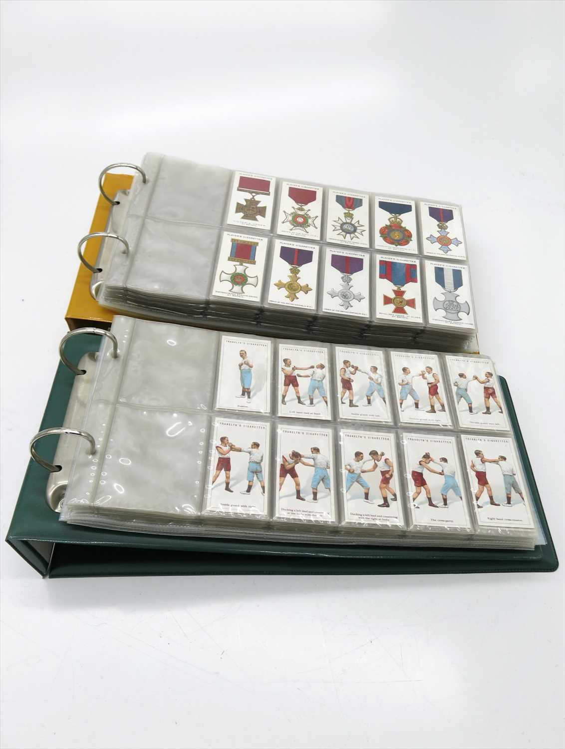 Lot 553 - Cigarette cards in two albums. 18 sets in