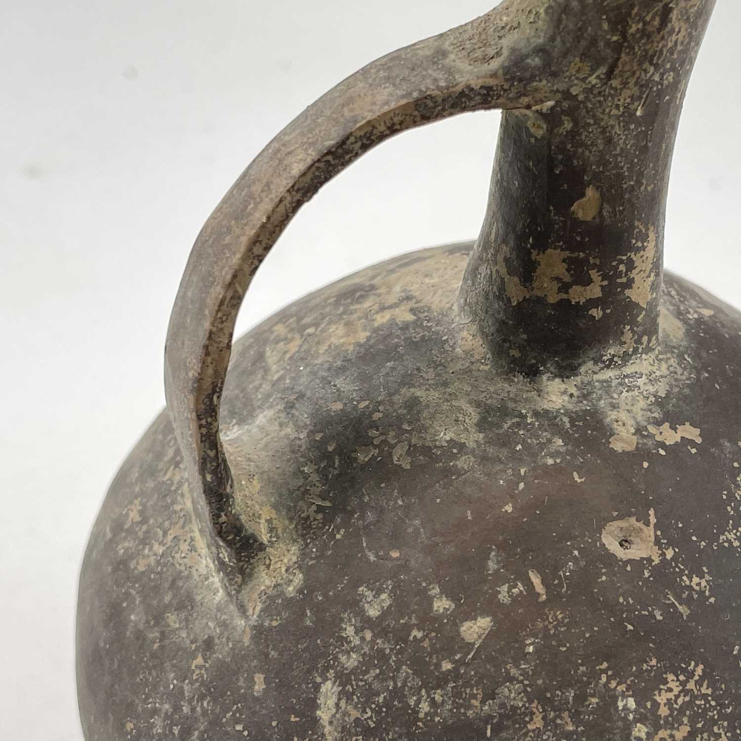 Lot 881 - An Anatolian pottery beak spout globular jug,