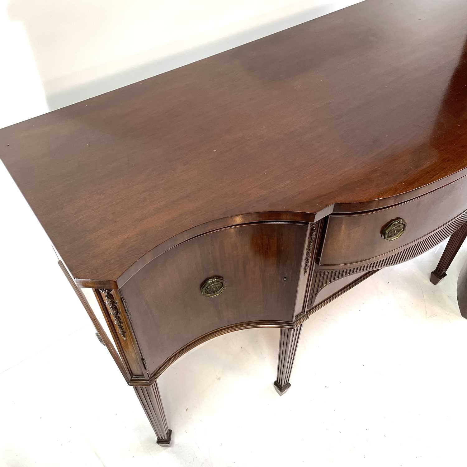 Lot 1889 - An Edwardian mahogany bow front sideboard.