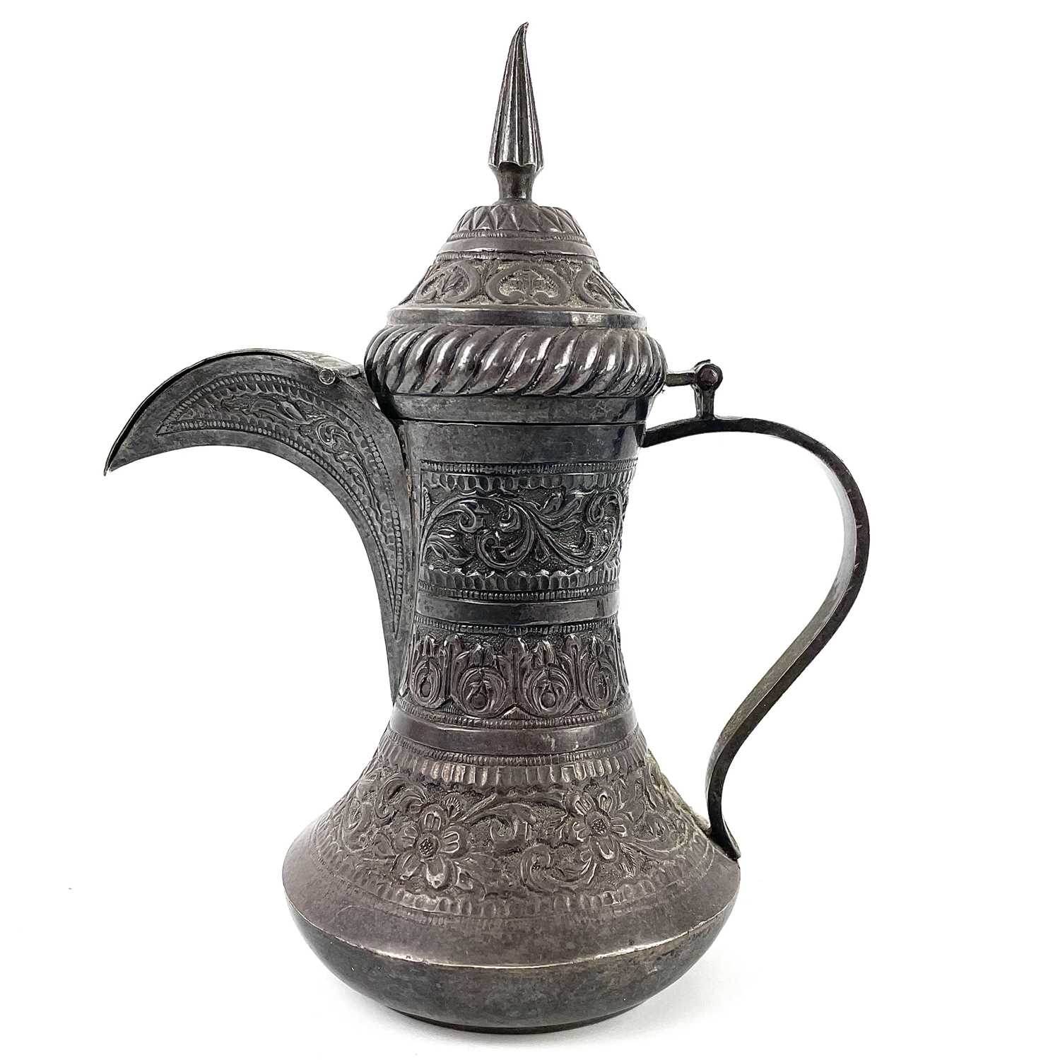 Lot 1042 - A Middle Eastern white metal dallah pot,