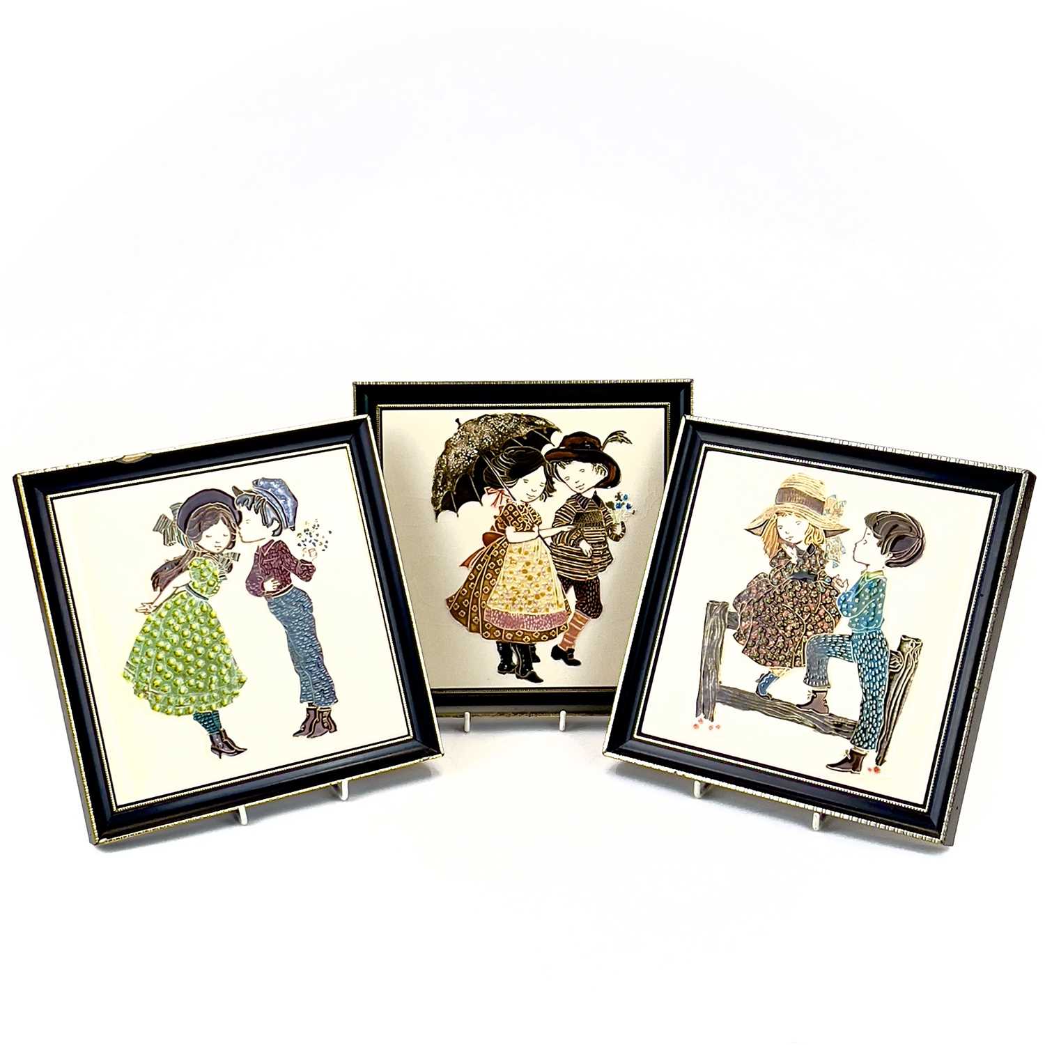 Lot 889 - Three Maw & Co framed tiles depicting young