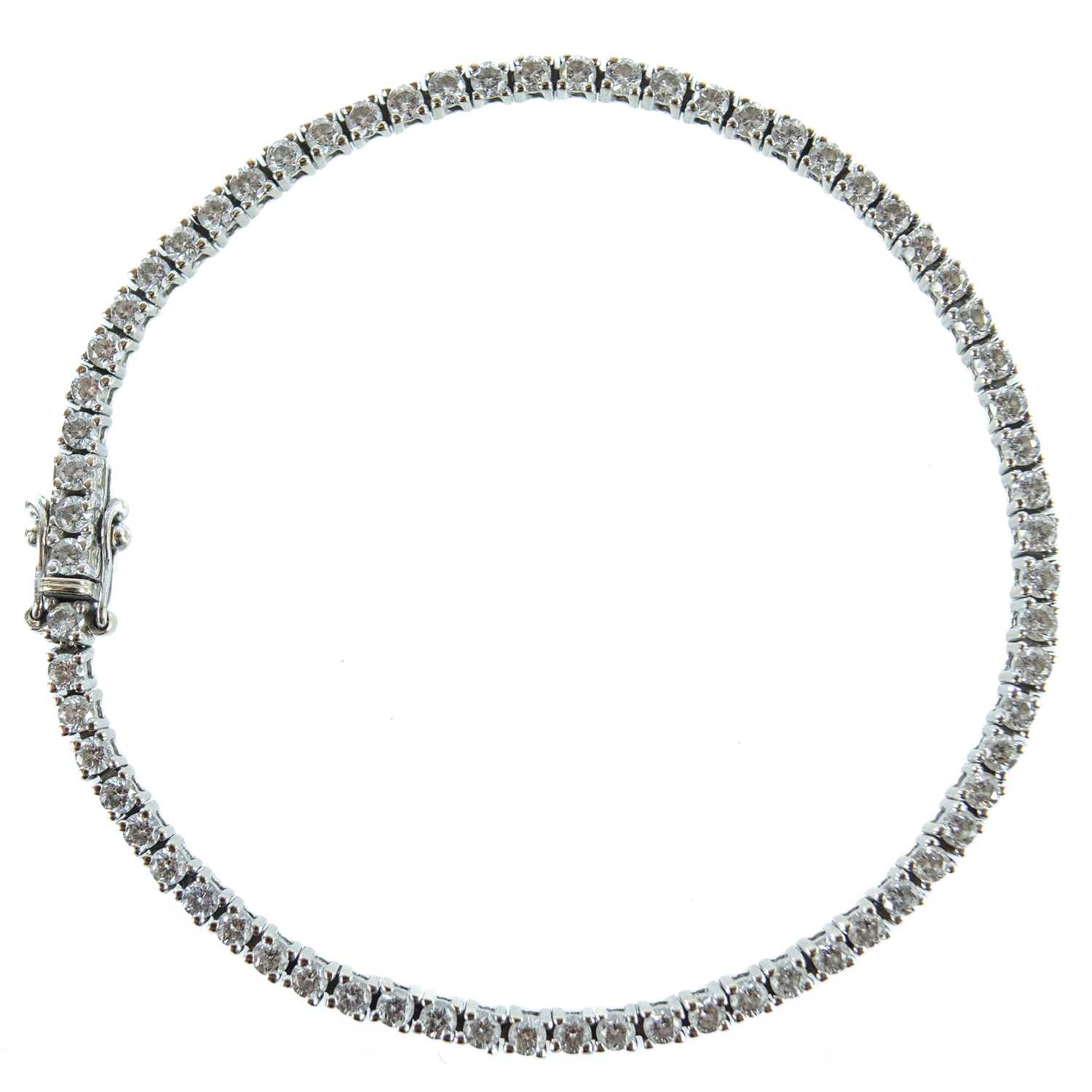 Lot 60 - An 18ct white gold diamond set line bracelet.