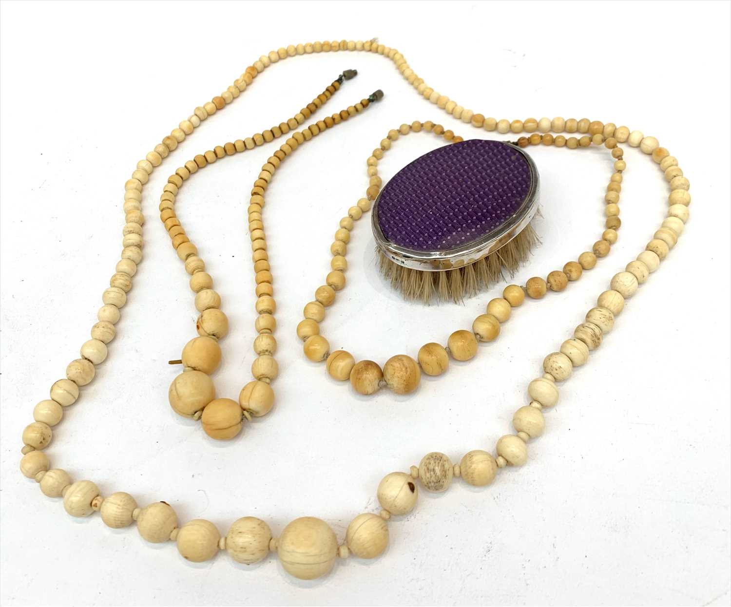 Lot 2457 - Three ivory necklaces and a silver mounted