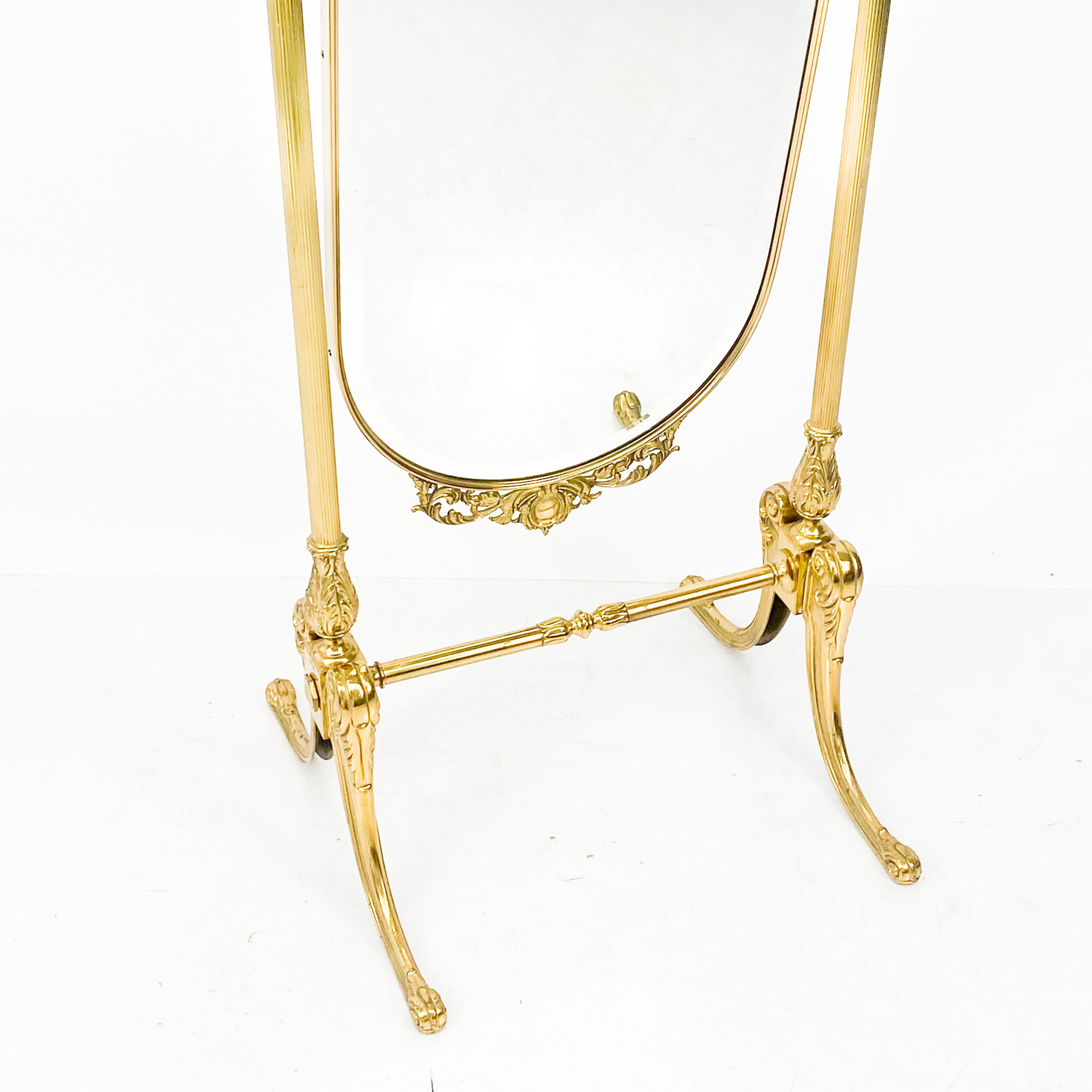 Lot 1967 - An ornate brass cheval mirror.