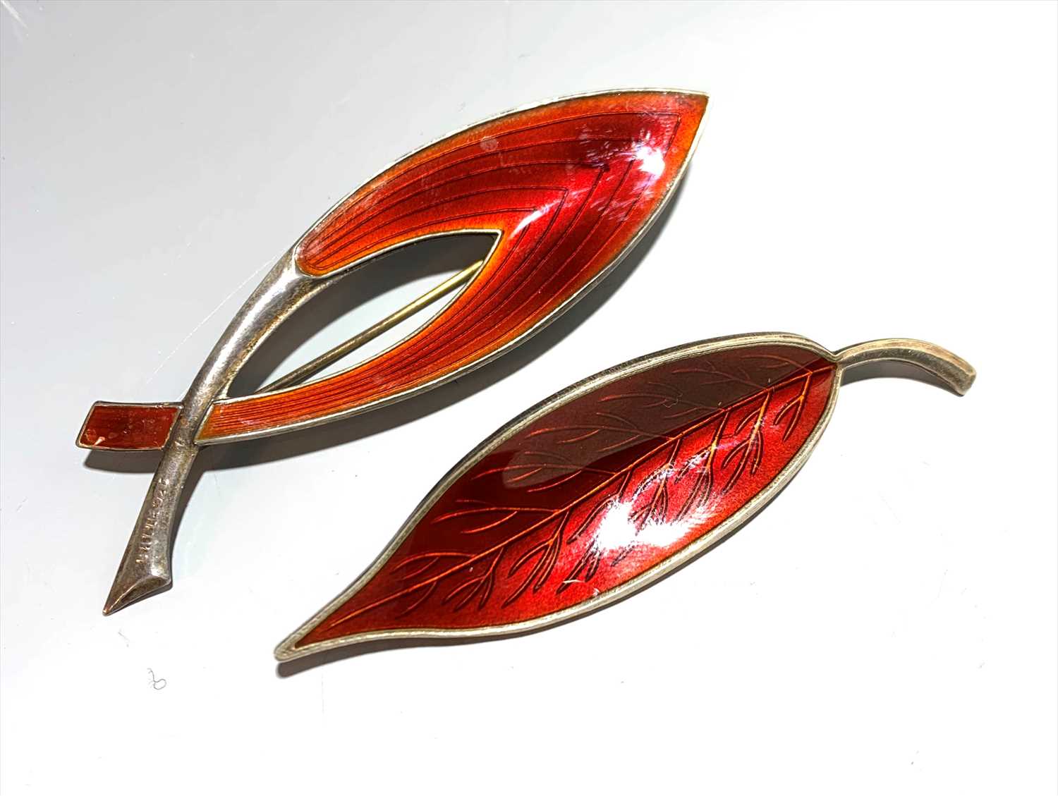 Lot 2612 - Two Danish silver and red enamel brooches,